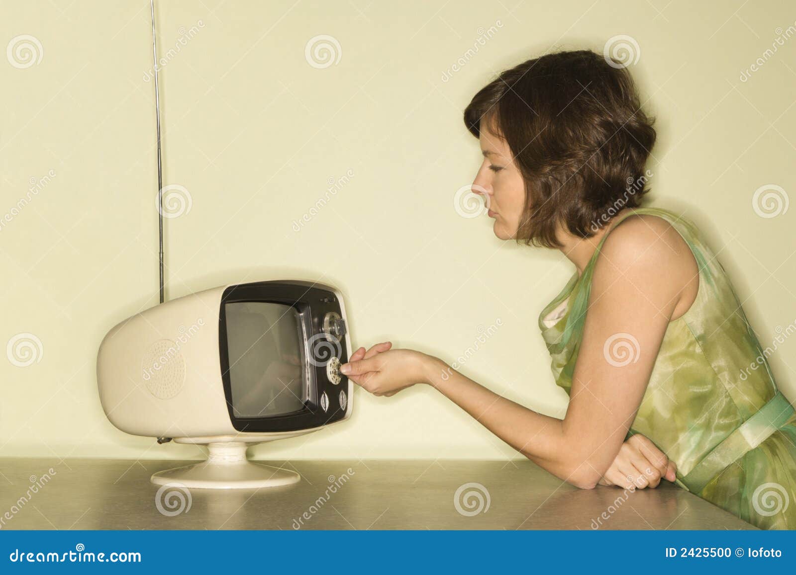 Woman dialing television. stock photo. Image of length - 2425500
