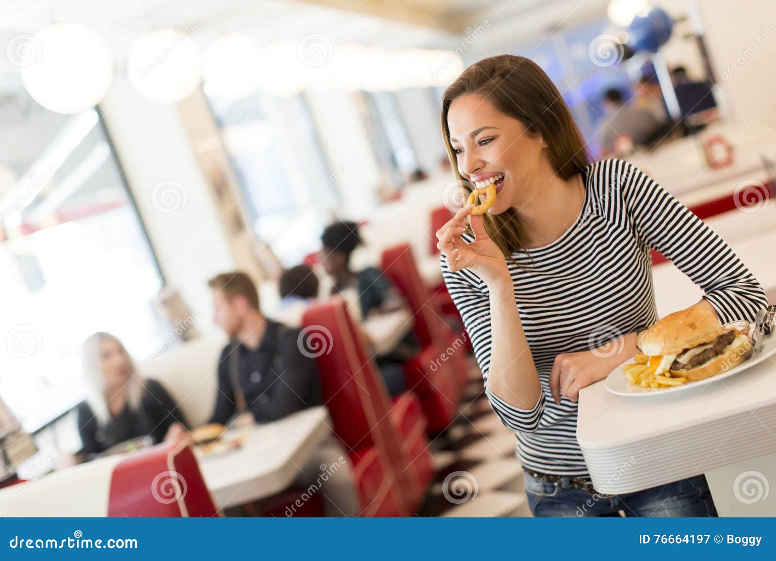 Woman in the diner stock image. Image of cheeseburger - 76664197