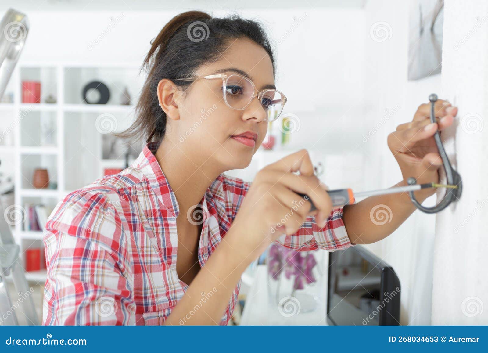 Woman during diy hook wall stock image. Image of living - 268034653