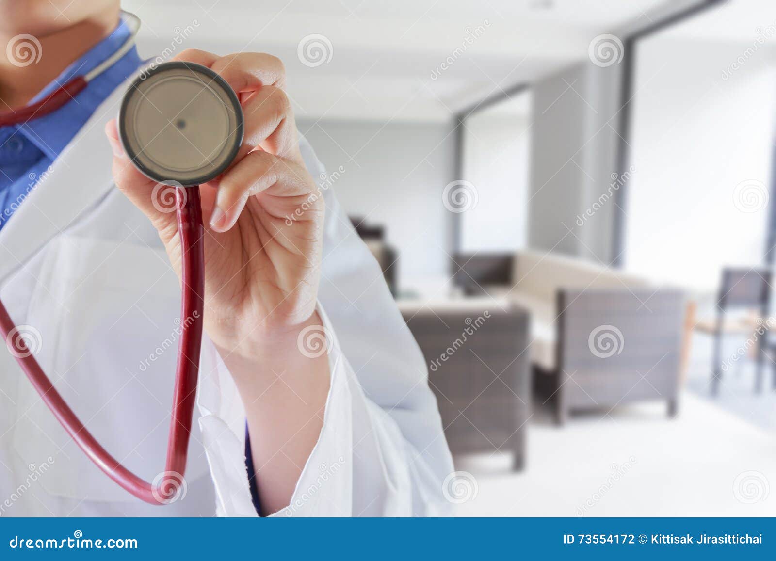 Woman Doctor Listening To Heartbeat With Stethoscope In Hospital Stock