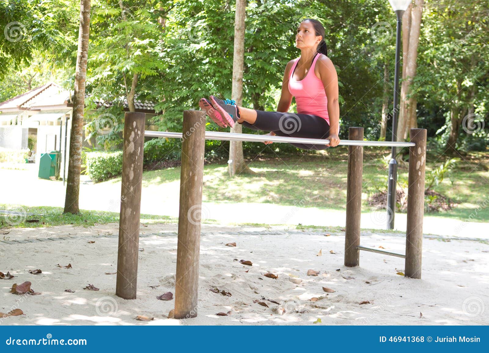 Woman Doing Dips Exercise on Balancing Bar in Park Stock Photo - Image ...