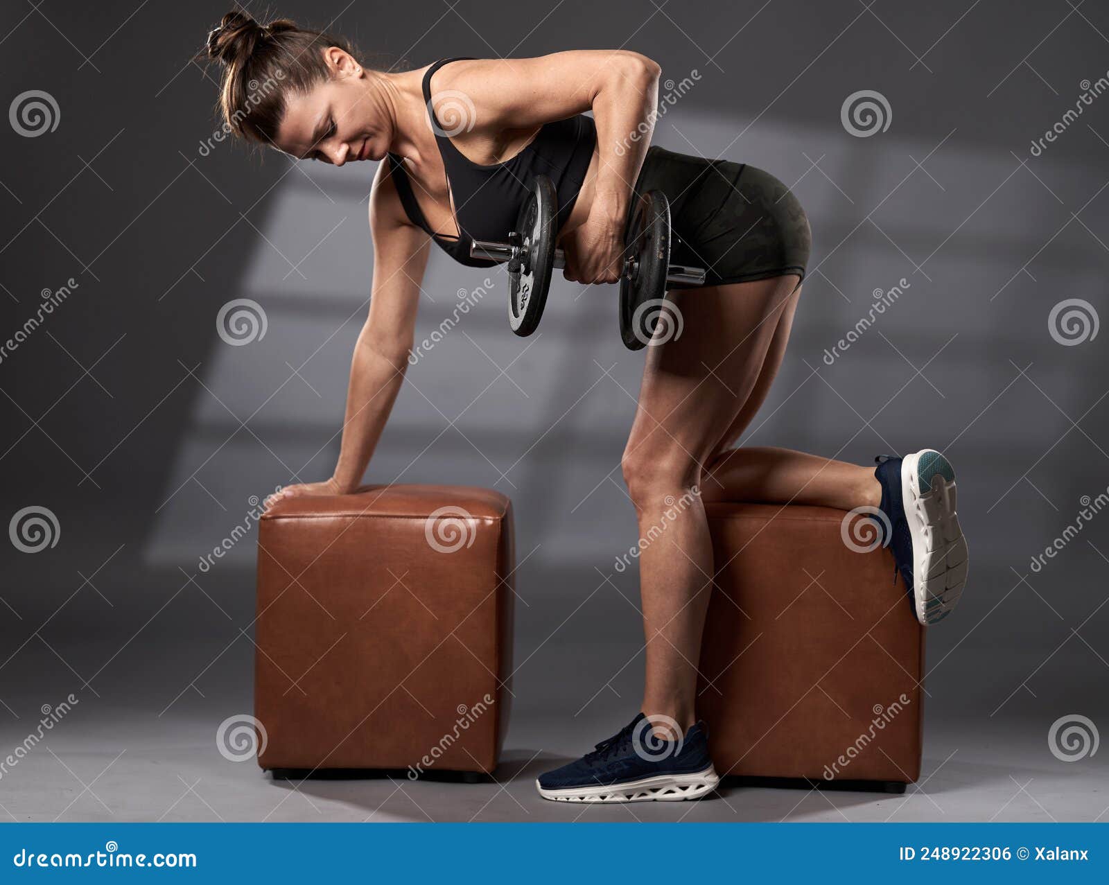 Woman Doing Back Workout with Dumbbell Stock Photo - Image of gray ...
