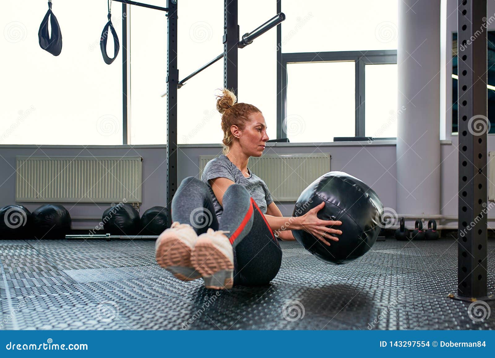 Woman Doing Exercises With Fitball In Fitness Gym Class Engaging Core