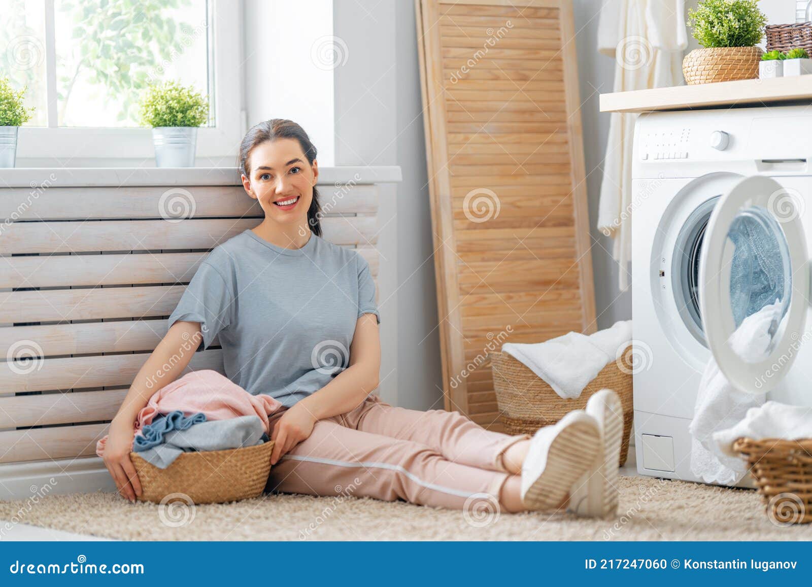 Woman is doing laundry stock photo. Image of basket - 217247060