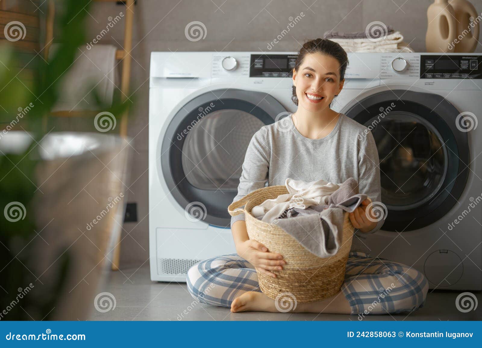 Woman is doing laundry stock image. Image of chore, laundry - 242858063