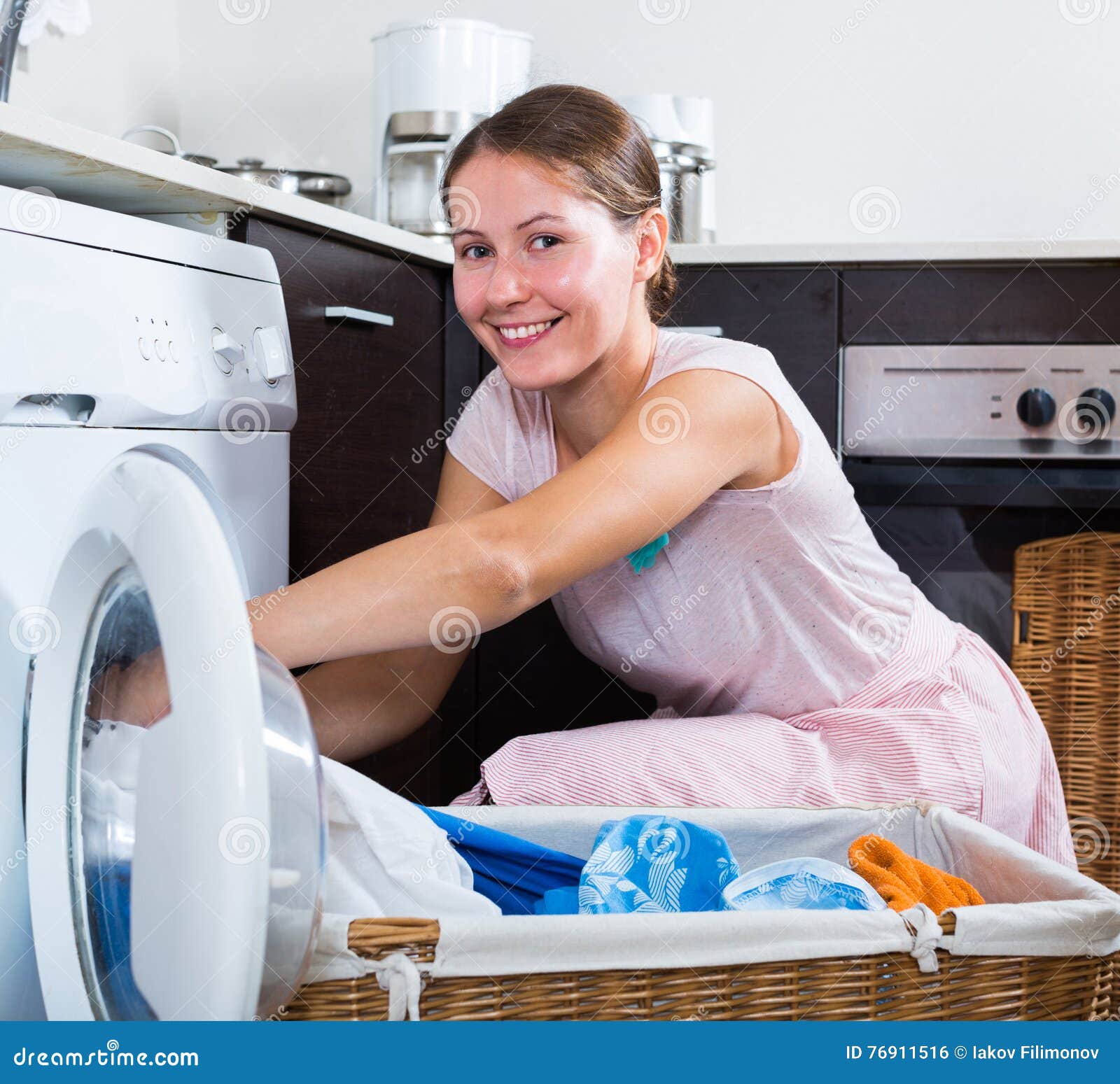 Woman doing laundry stock photo. Image of interior, casual - 76911516