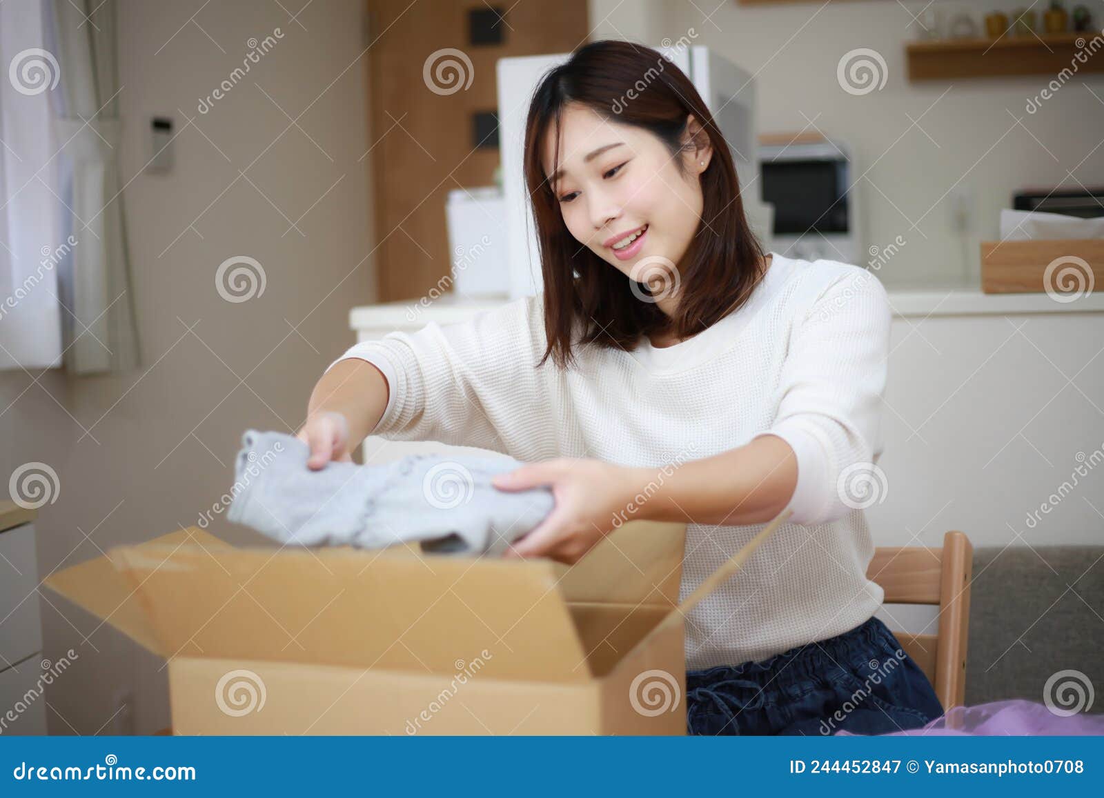 Woman doing packing work stock image. Image of dwelling - 244452847