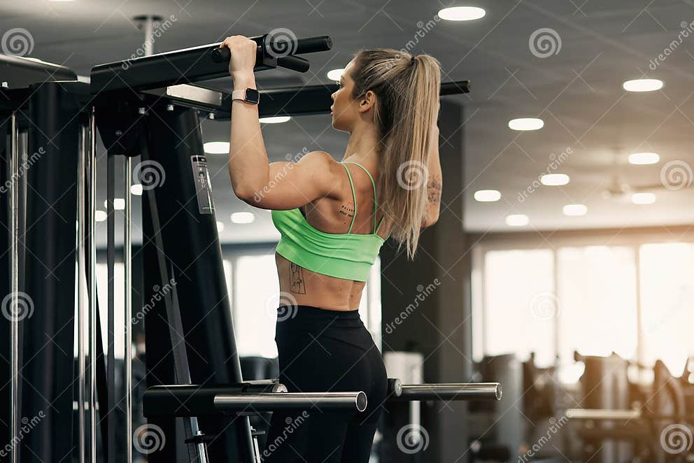 Woman Doing Pull Ups Exercise Training Arms and Back in the Gym. Upper Body Training Stock Image ...