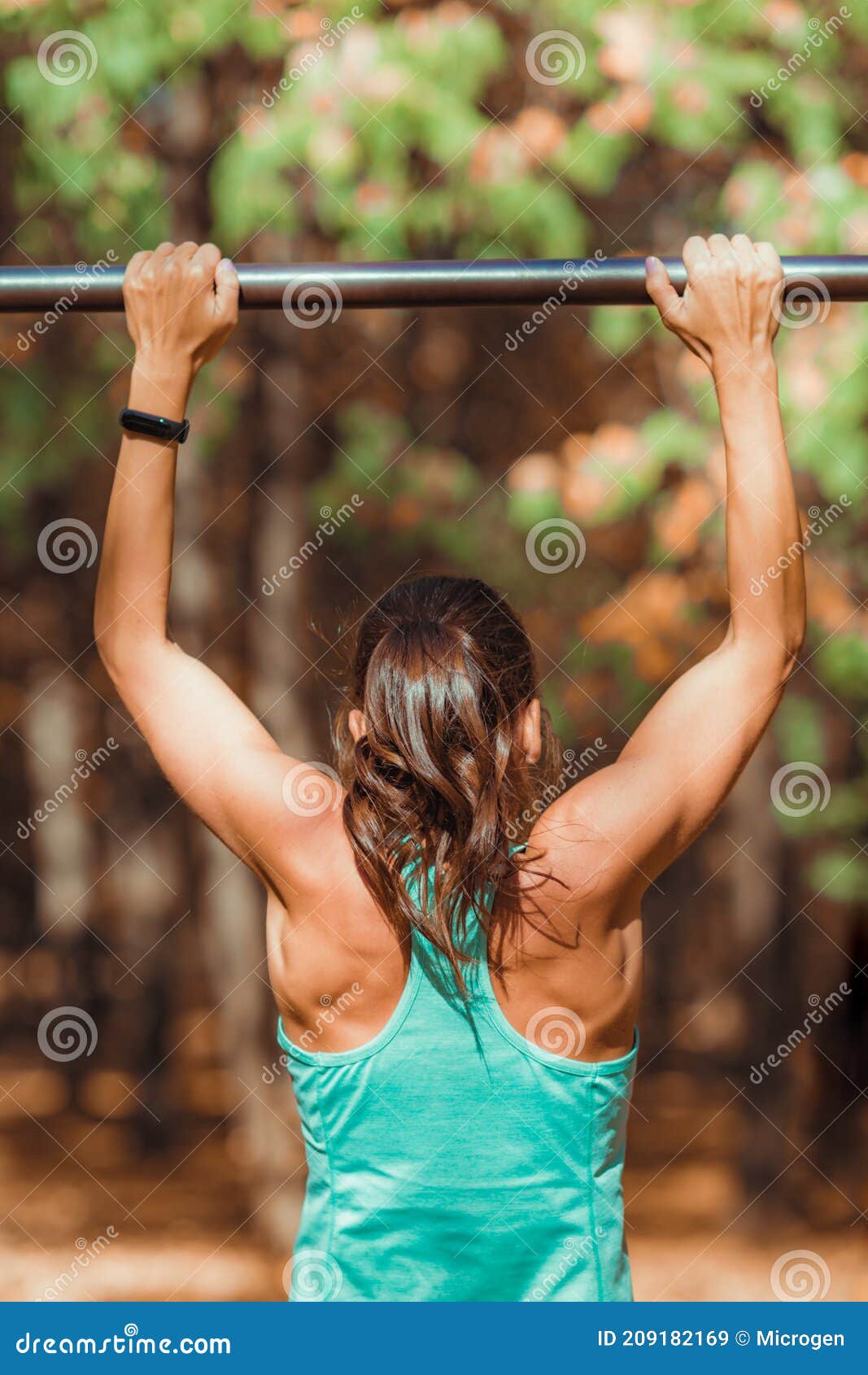 Woman doing pull-ups stock image. Image of exercising - 209182169