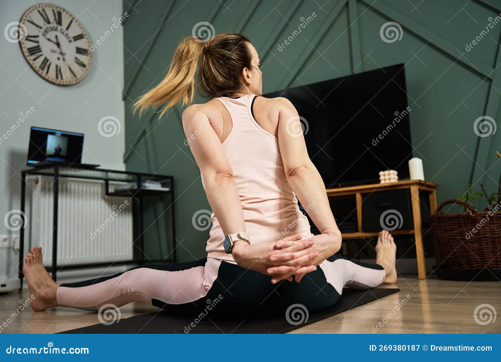 Woman Doing Sport Exercises At Home Watching Online Tutorial On Laptop