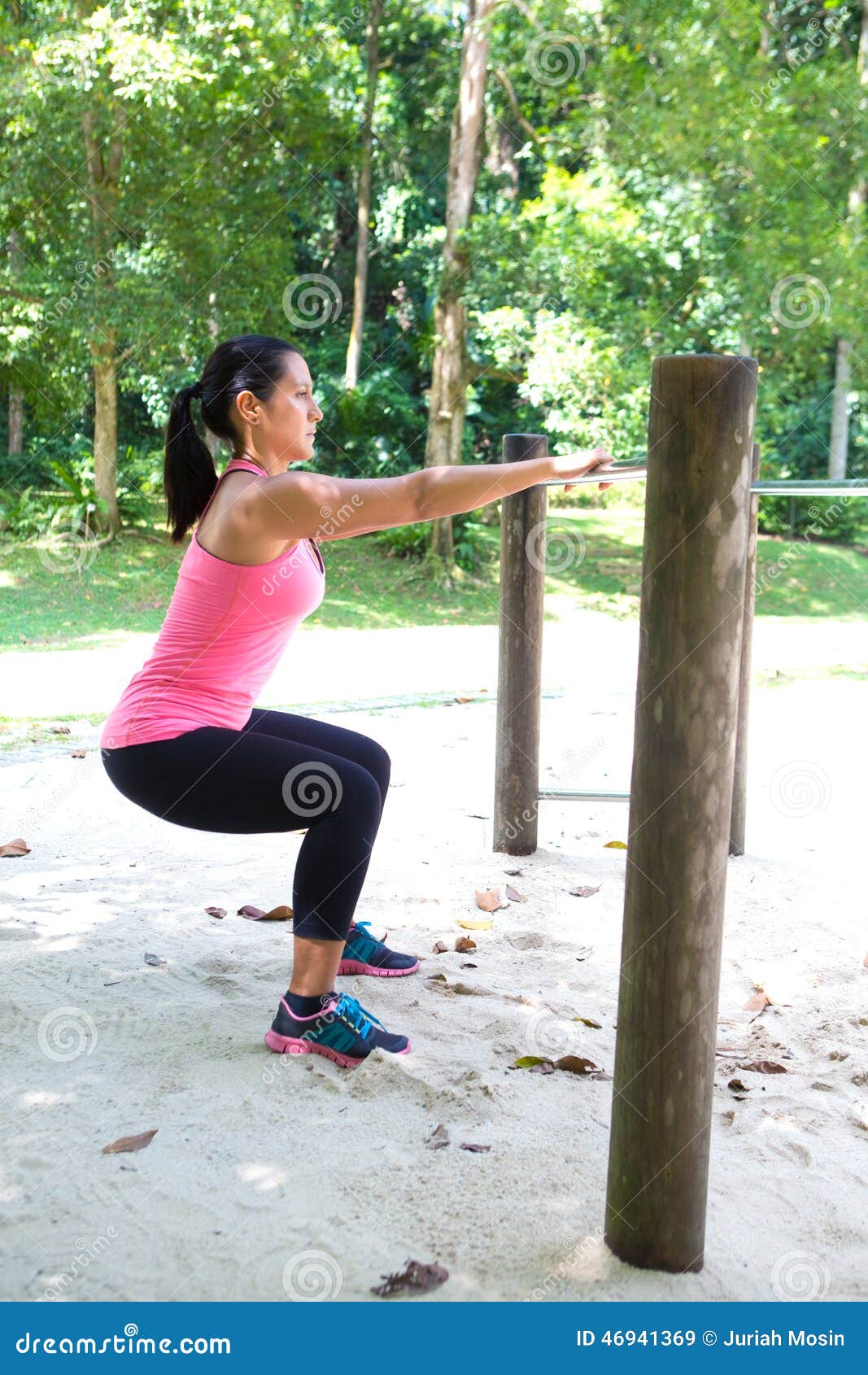 Woman Doing Squat Exercise by the Exercise Bar in the Park Stock Image ...