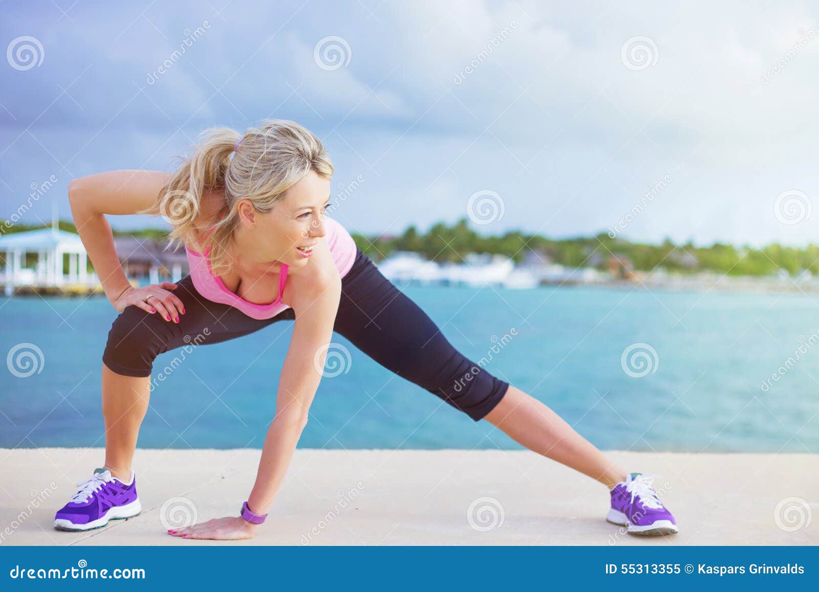 Woman Doing Stretching Exercises before Morning Workout Outdoors Stock ...