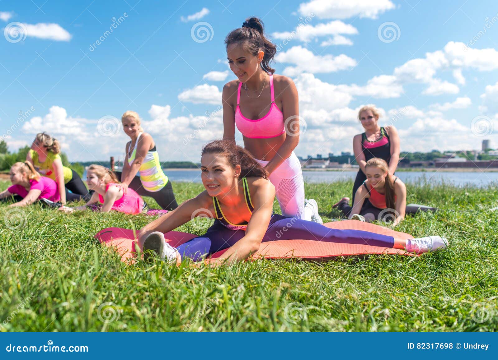 Woman Doing Stretching Workout for Back Muscles with Trainer Stock ...