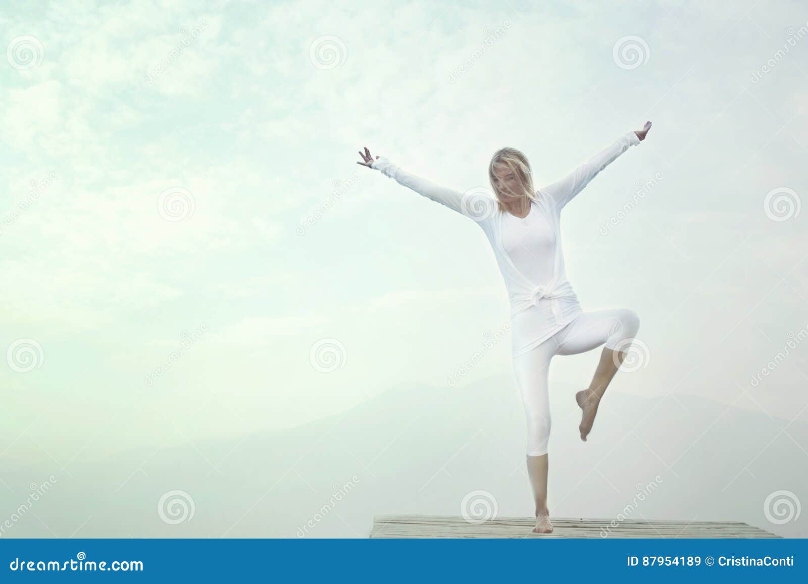 Woman Doing Yoga Exercises in Front of a Blue Sky Stock Image - Image ...
