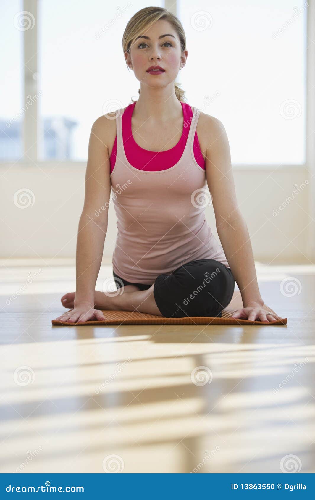 Woman Doing Yoga on Mat in Studio Stock Photo - Image of woman ...