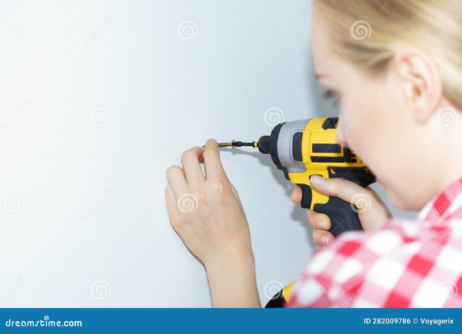 Woman drilling in wall stock photo. Image of wall, electric - 282009786