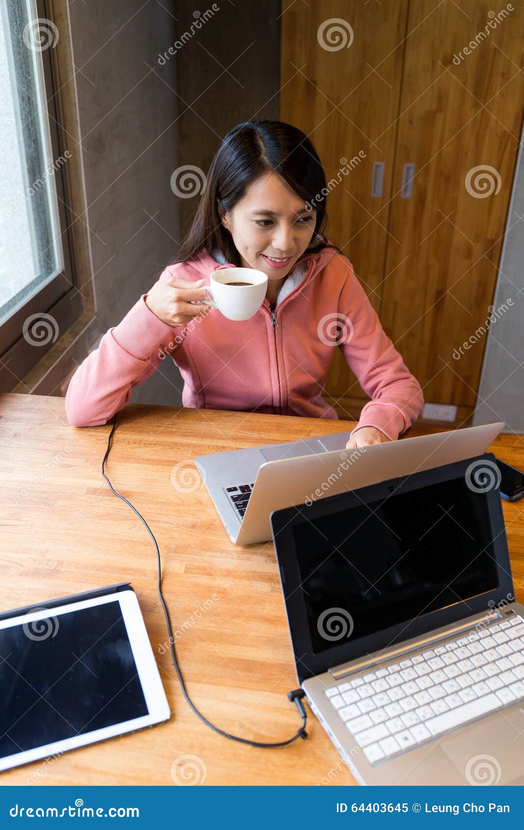 Woman Drinking a Cup of Tea and Using the Laptop Computer Stock Image ...