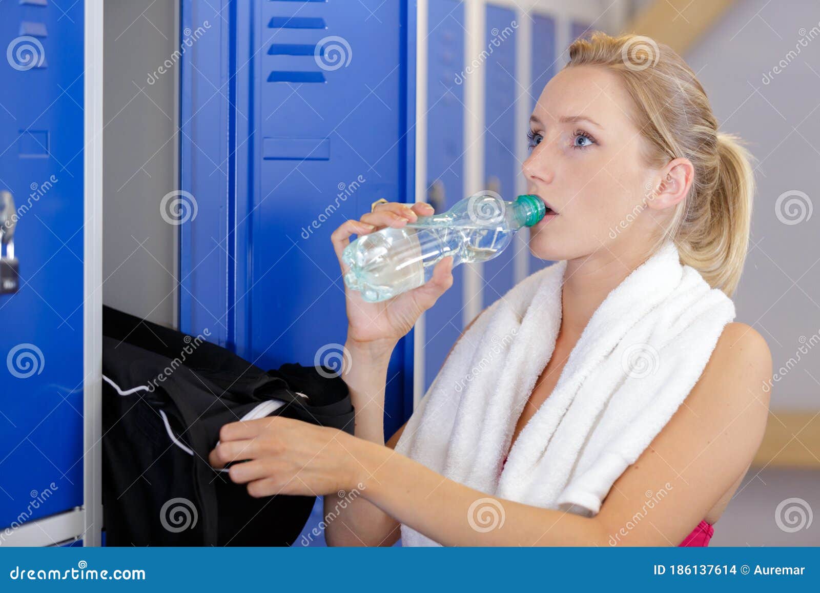 Woman Drinking Water in Locker Room Stock Photo - Image of beautiful ...