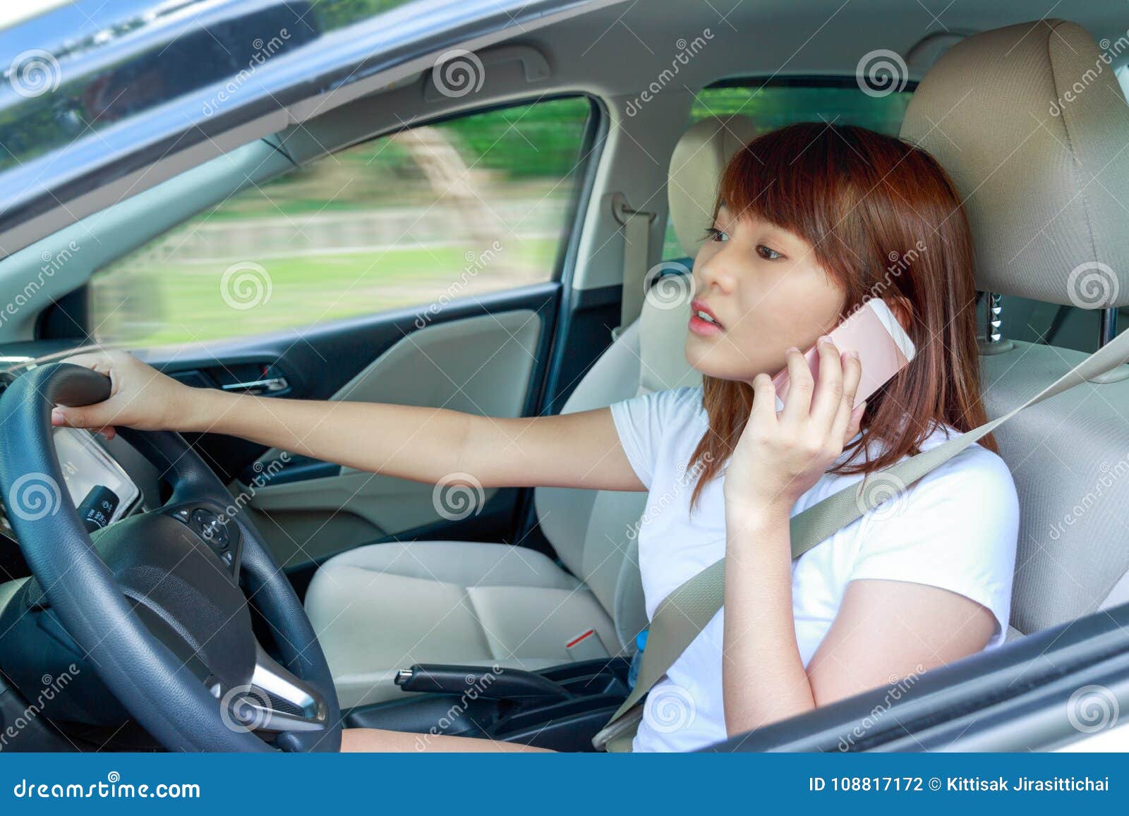 Woman Driving Fast A Car Distracted On The Phone And Looking On Stock