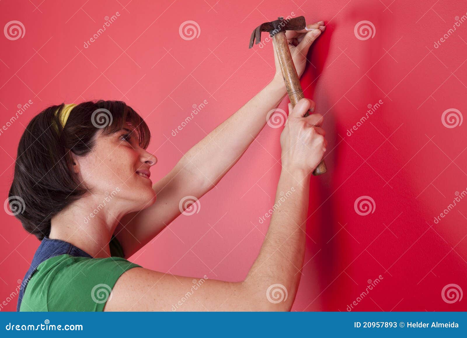 Woman driving a nail stock image. Image of domestic, handy - 20957893
