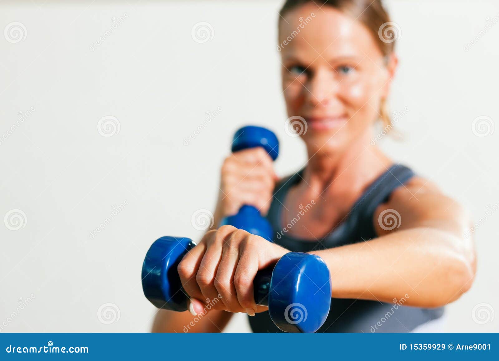 Woman with dumbbell in gym stock image. Image of exercising - 15359929