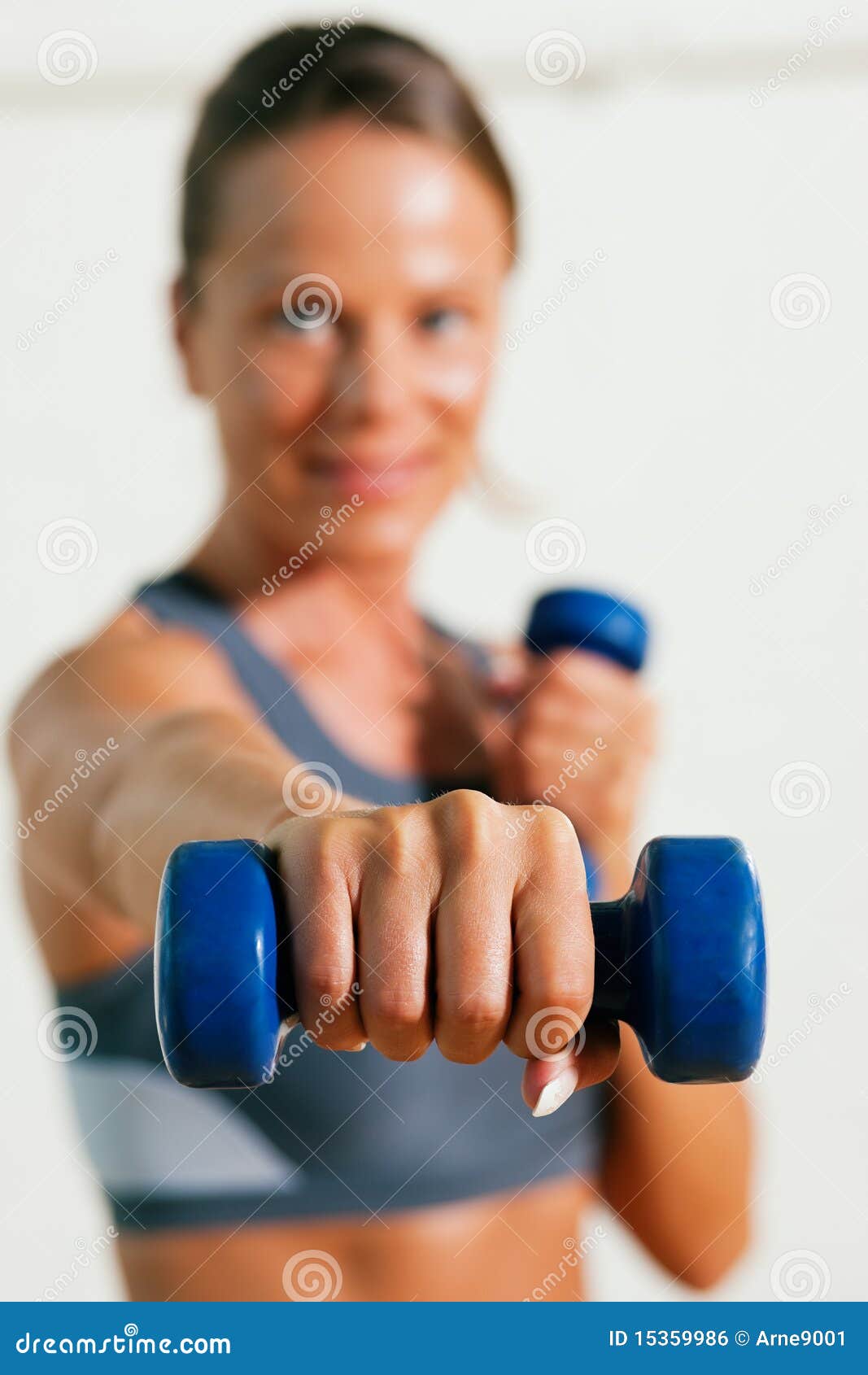 Woman with dumbbell in gym stock photo. Image of person - 15359986