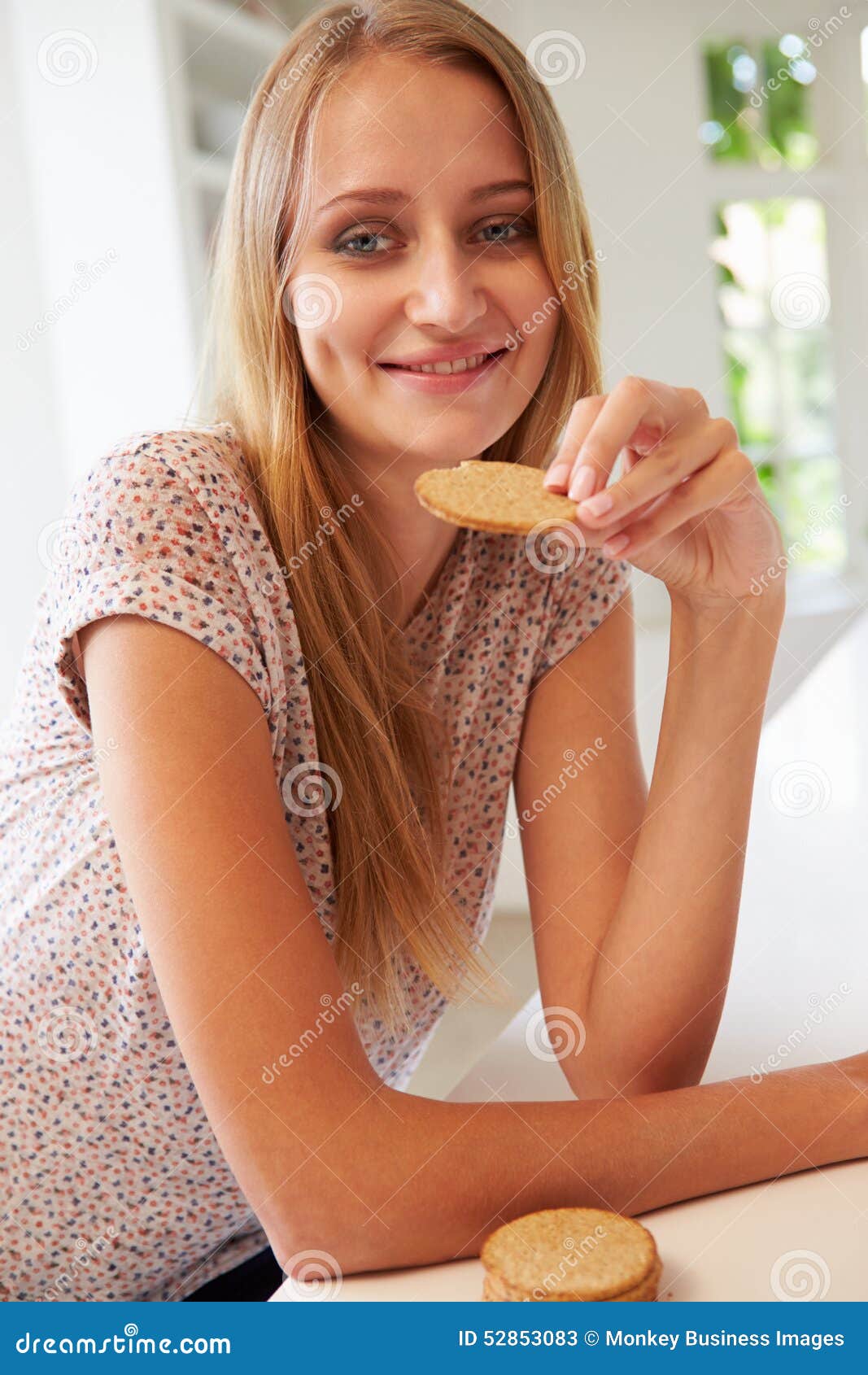 Woman Eating Biscuits in Kitchen Stock Image - Image of adult, camera ...