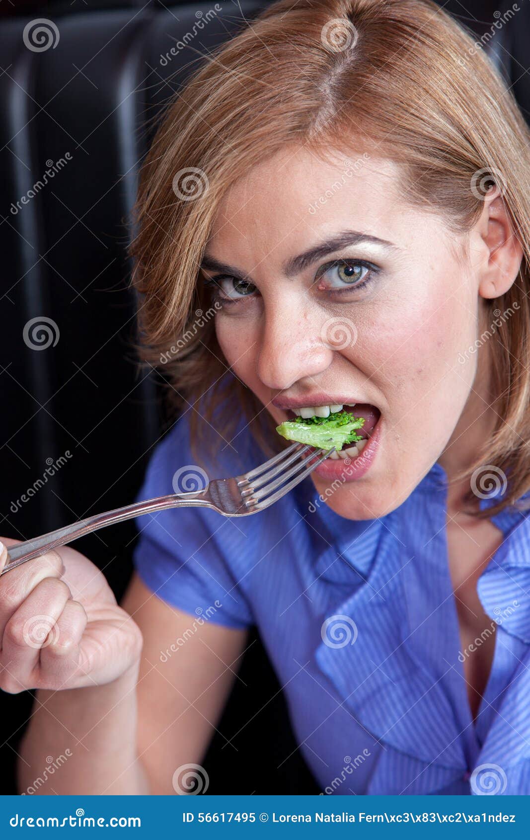 Woman is eating broccoli stock image. Image of holding - 56617495