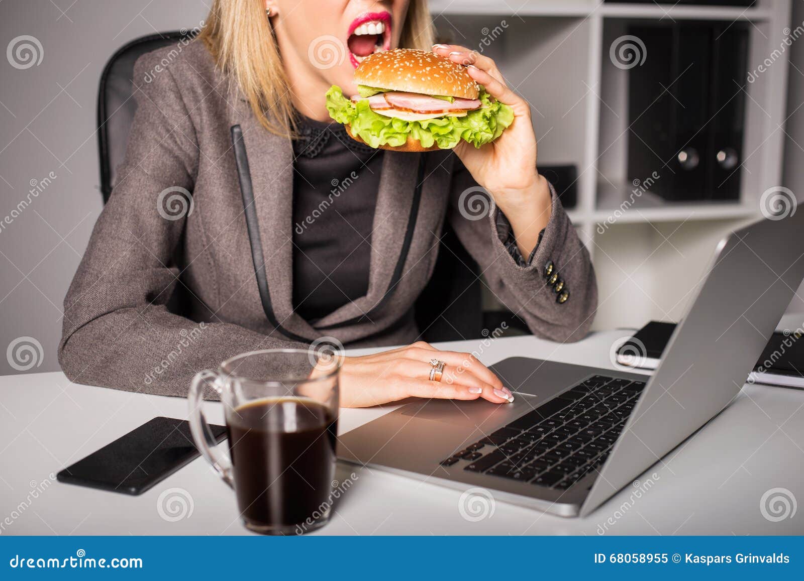 Woman Eating Burger while Working Stock Image - Image of sandwich ...