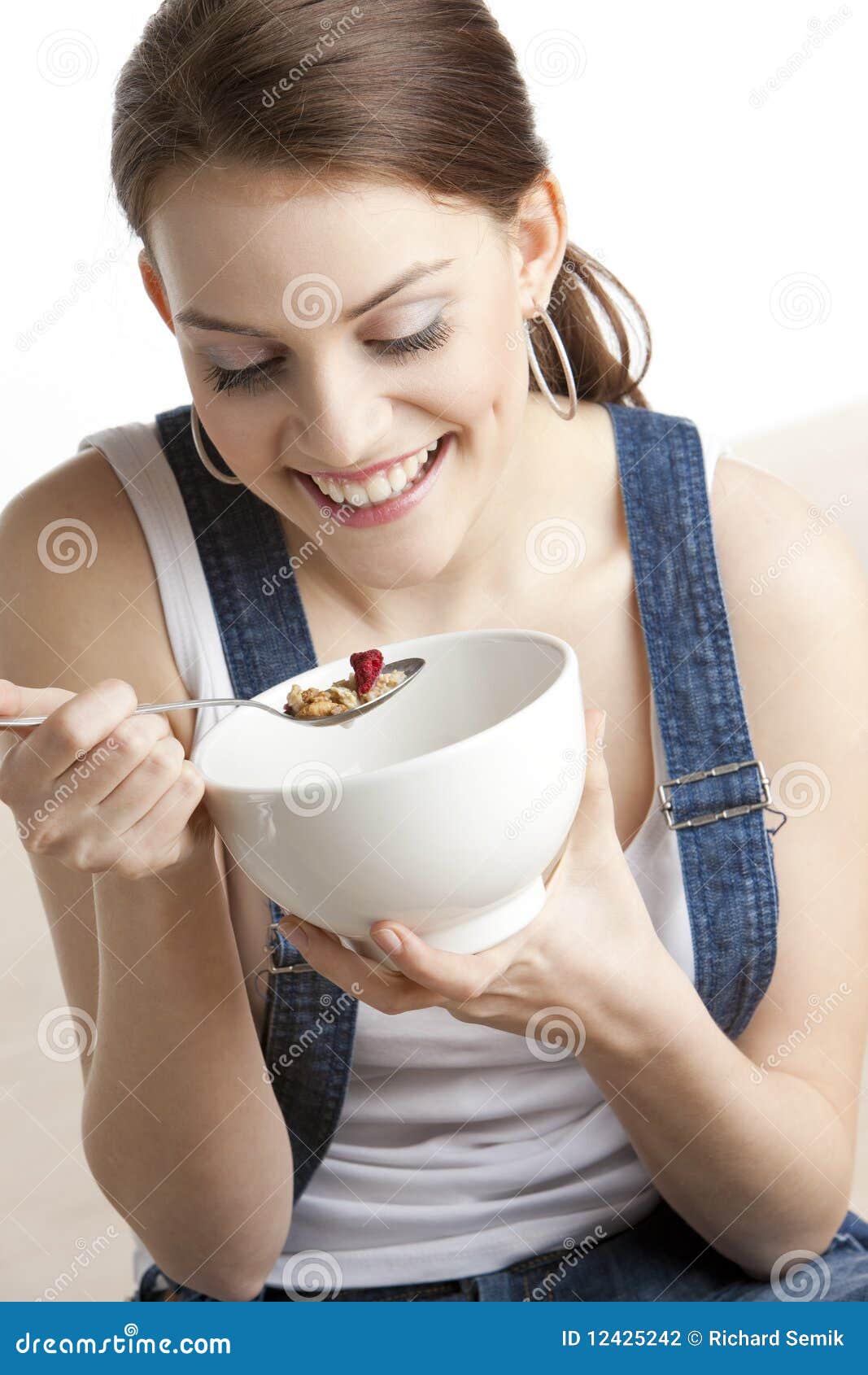 Woman eating cereals stock photo. Image of hold, foodstuff - 12425242