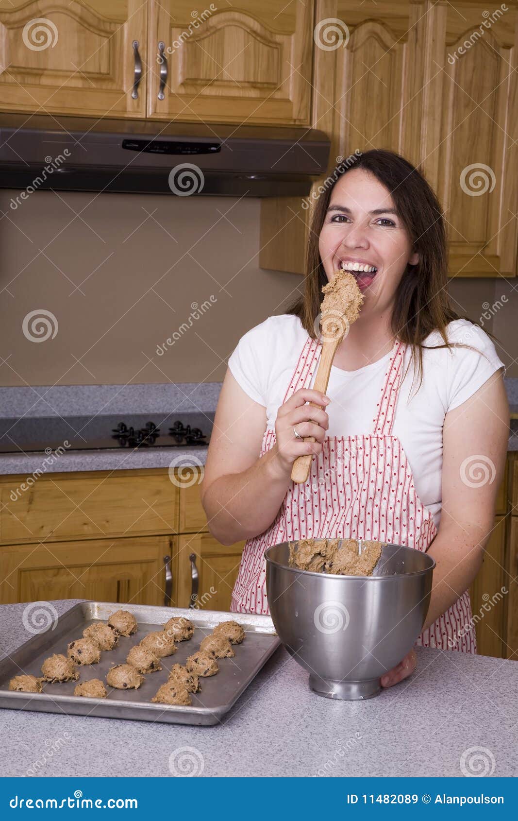 Woman eating cookie dough stock image. Image of isolated - 11482089