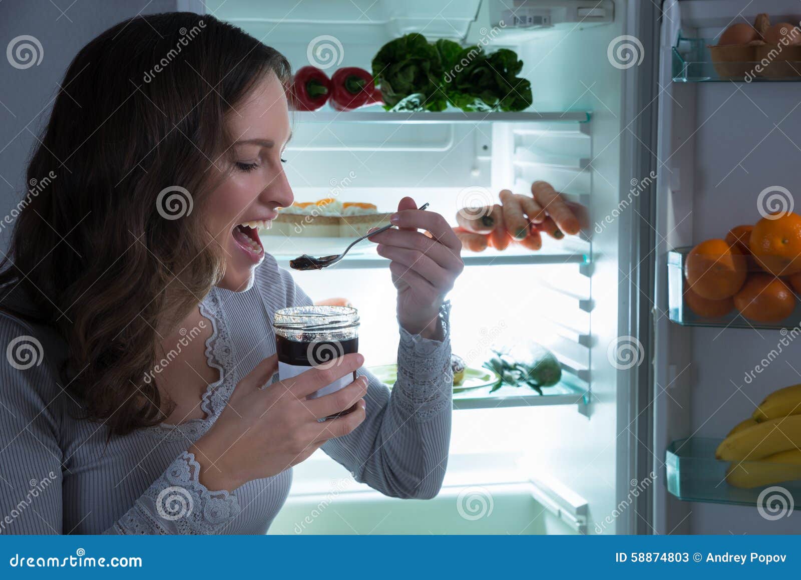 Woman Eating in Front of Fridge Stock Image - Image of home, freshness ...