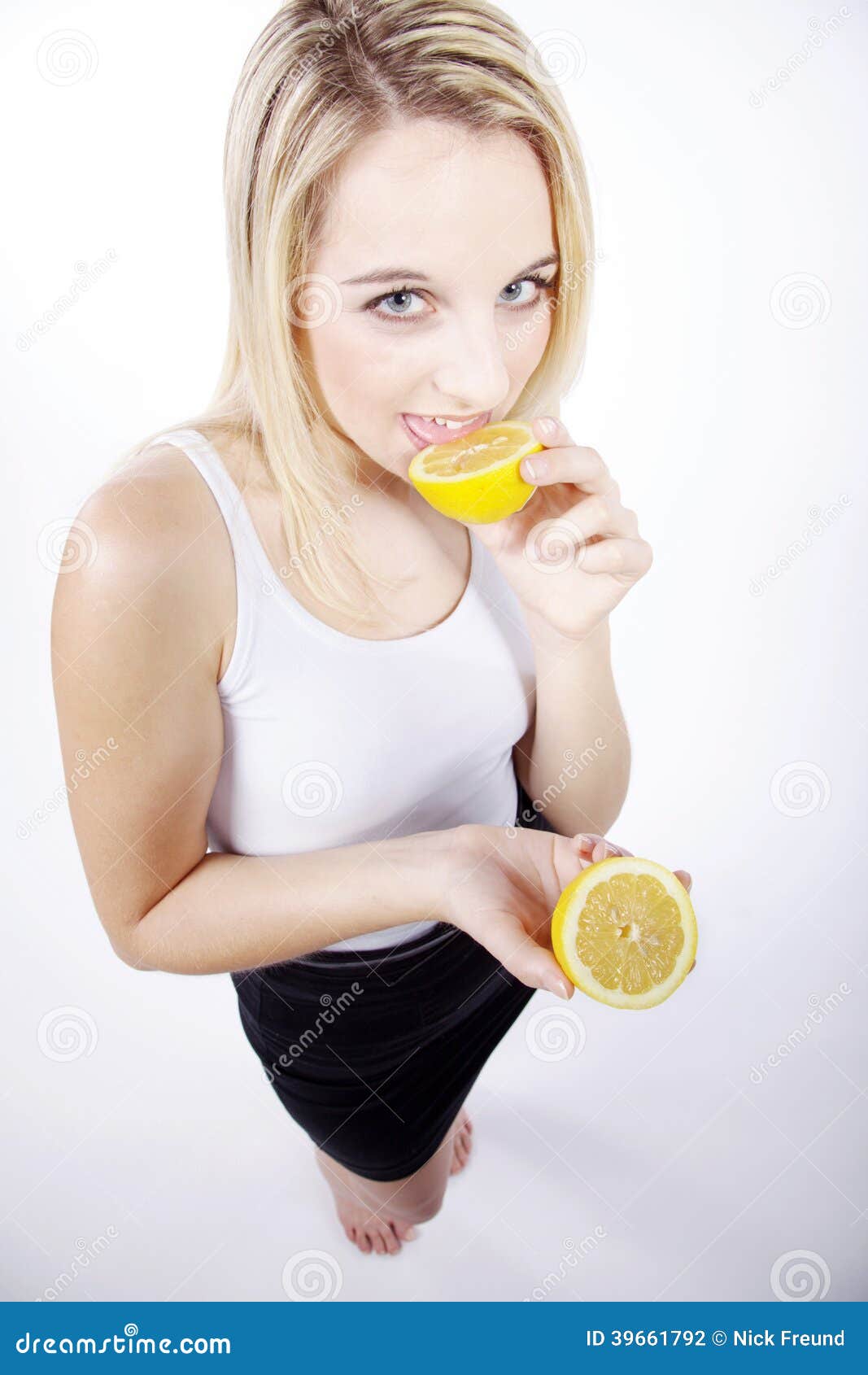 Woman eating a lemon stock photo. Image of beauty, hair - 39661792