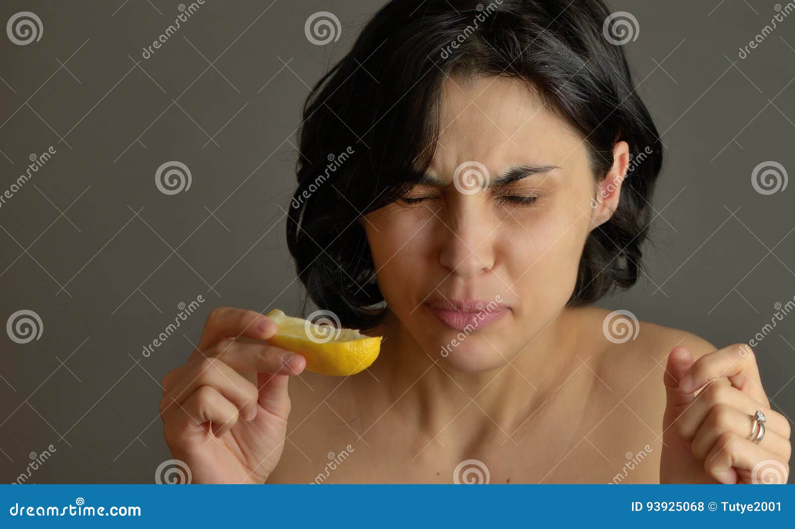 Woman Eating Lemon and Making Silly Faces Isolated Stock Photo - Image ...