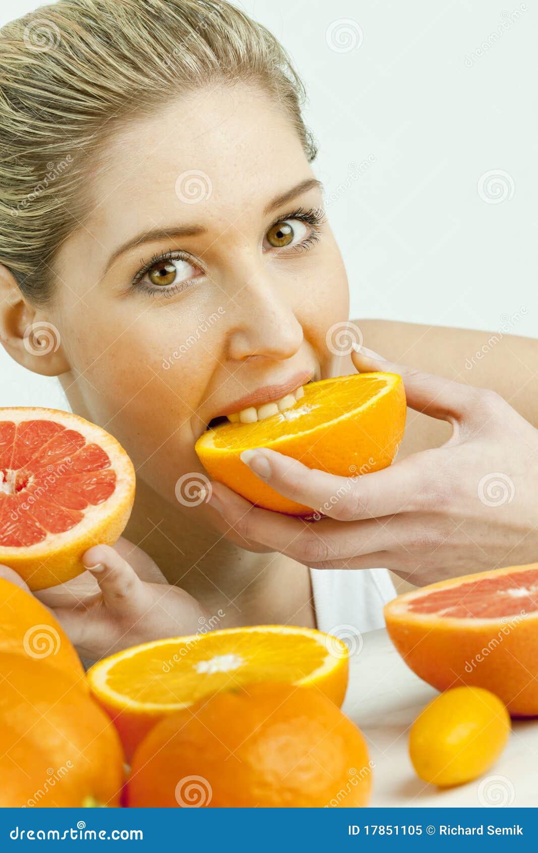 Woman eating orange stock image. Image of people, emotion - 17851105