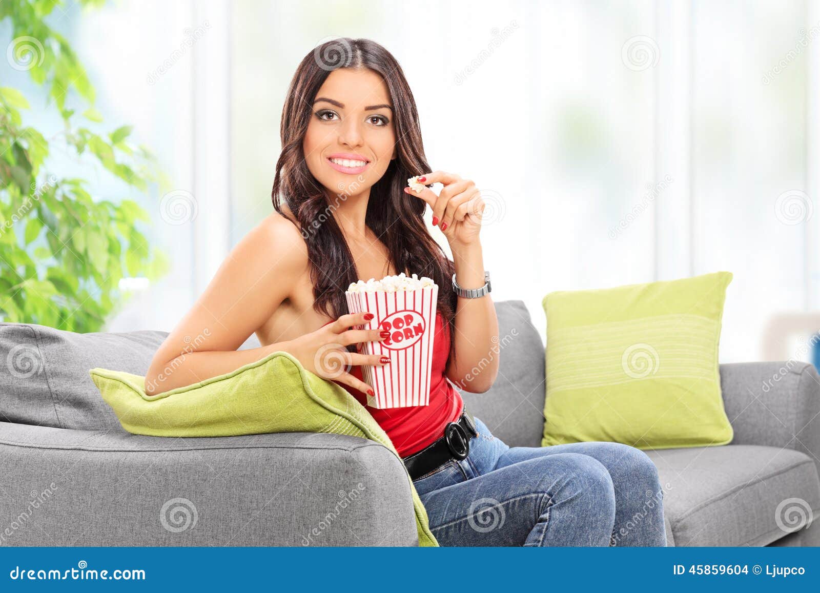 Woman Eating Popcorn Seated on Sofa at Home Stock Photo - Image of calm ...