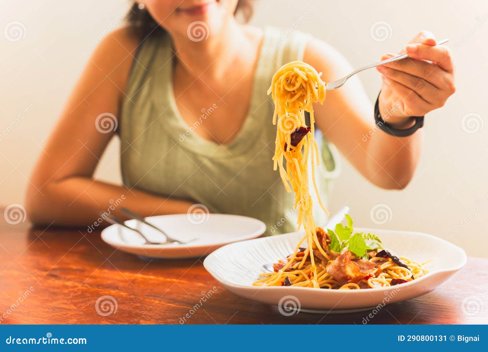 Woman Eating Spaghetti with Friend in Restaurant. Stock Image - Image ...