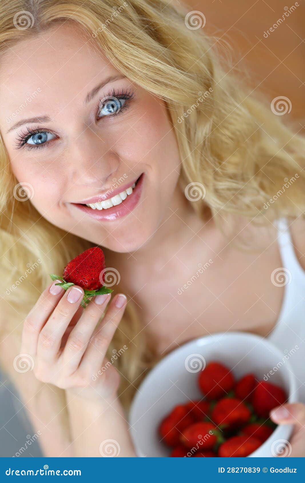 Woman eating strawberries stock image. Image of blond - 28270839