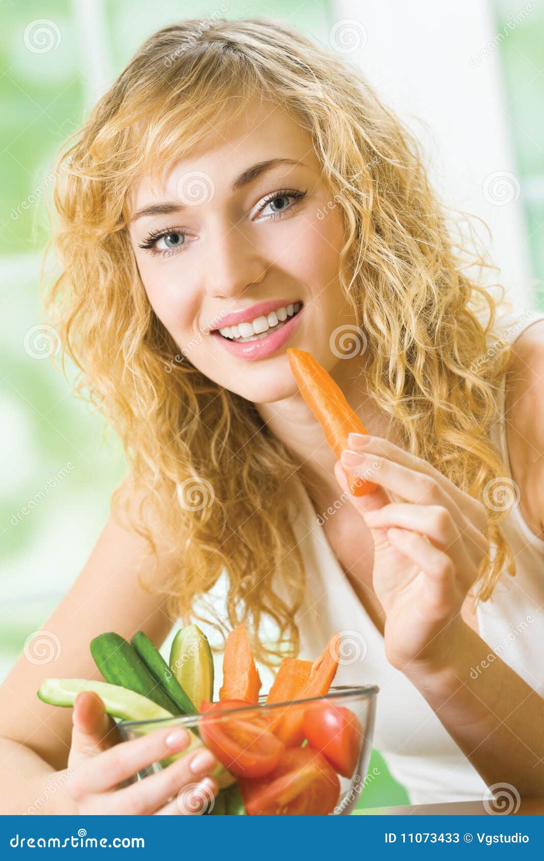 Woman eating vegetables stock image. Image of camera - 11073433