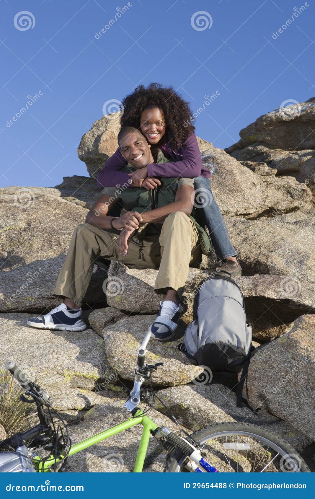 Woman Embracing Man while Sitting on Rocks Stock Photo - Image of ...