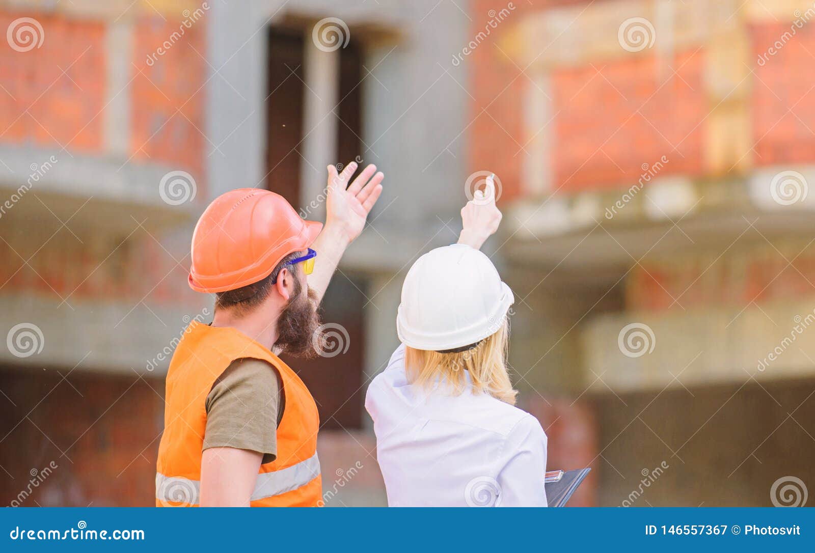 Woman Engineer and Builder Communicate Construction Site. Relationships ...