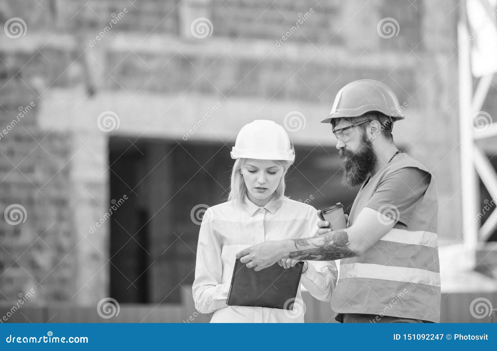 Woman Engineer and Builder Communicate Construction Site. Construction ...