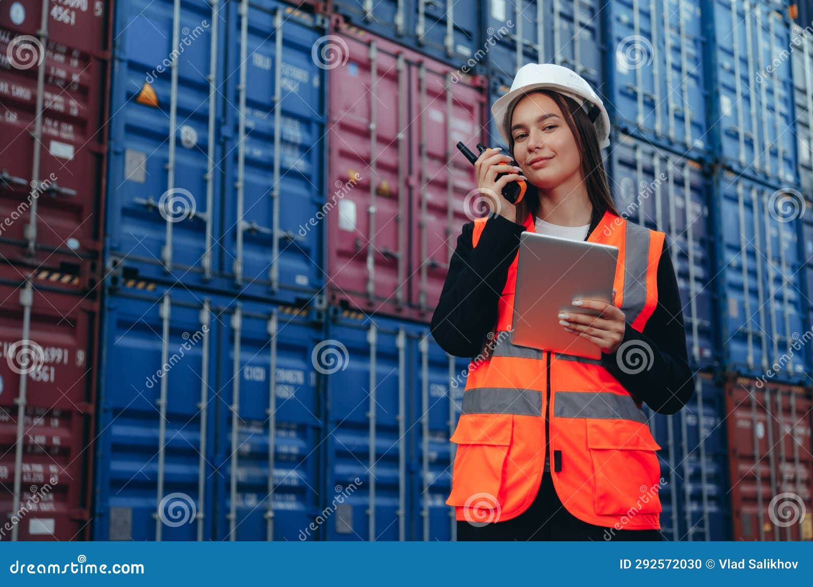 Woman Engineer, Using a Communication Radio and Working in Shipment ...