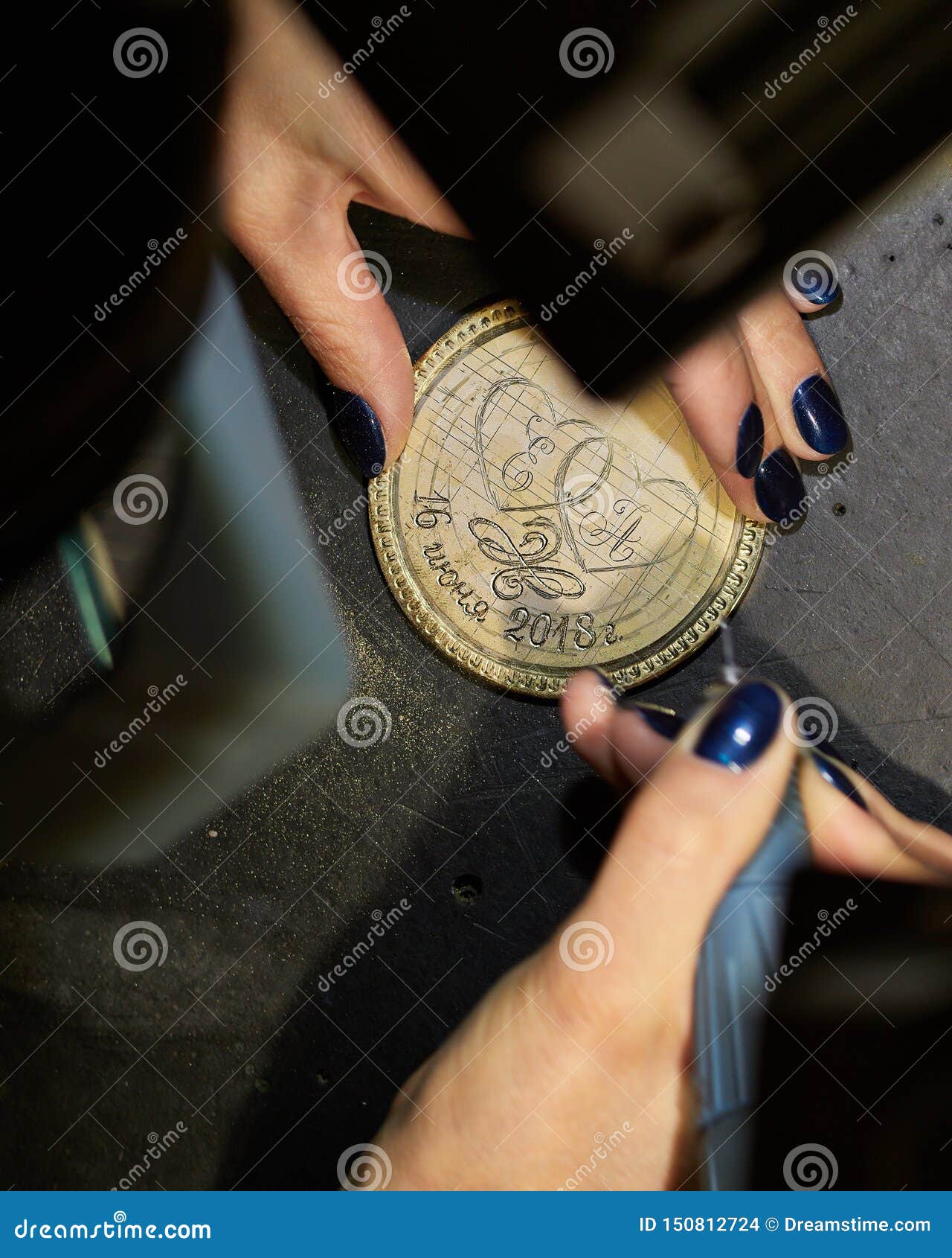 Woman engraver at work. stock photo. Image of engraving - 150812724