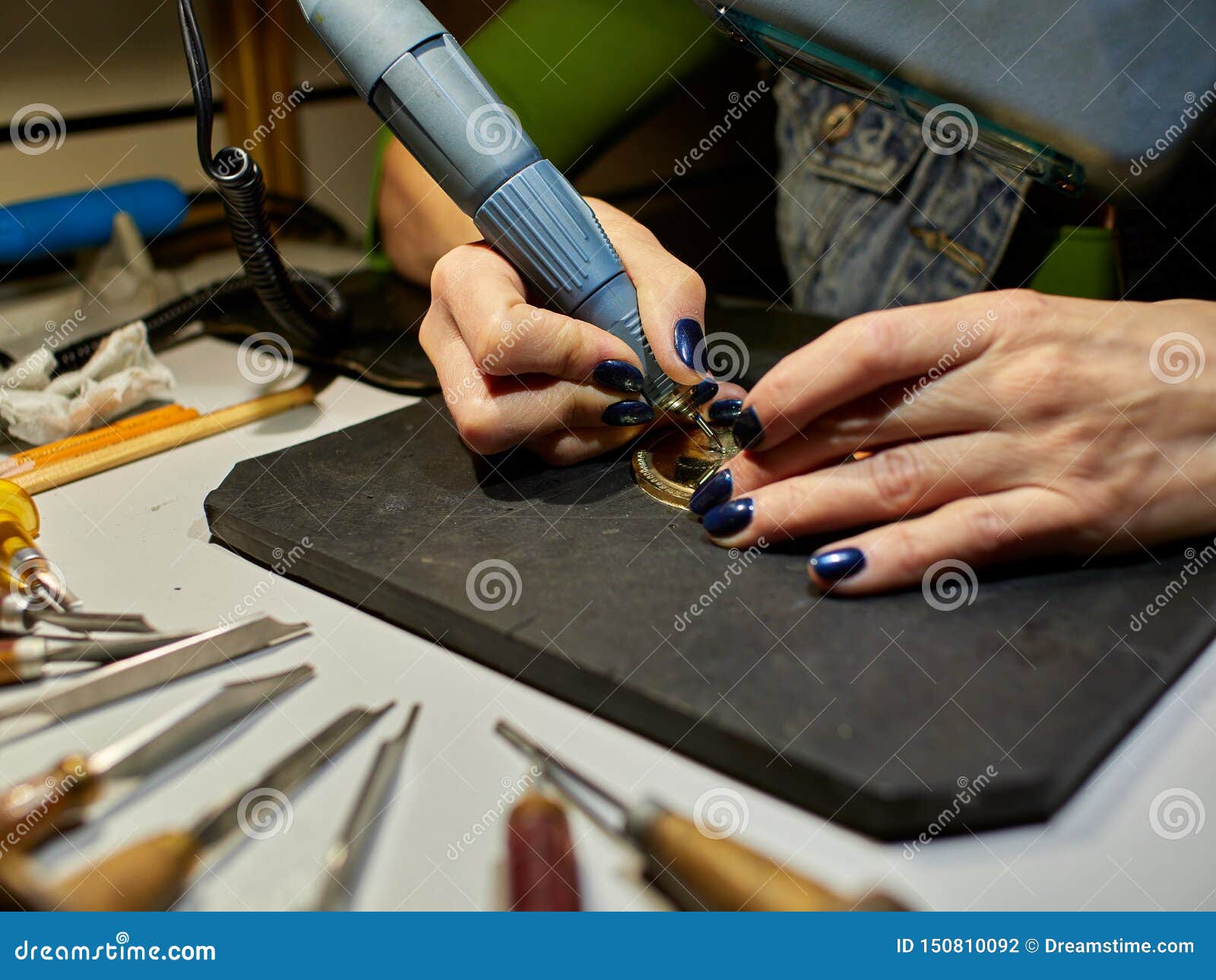 Woman engraver at work. stock photo. Image of medal - 150810092