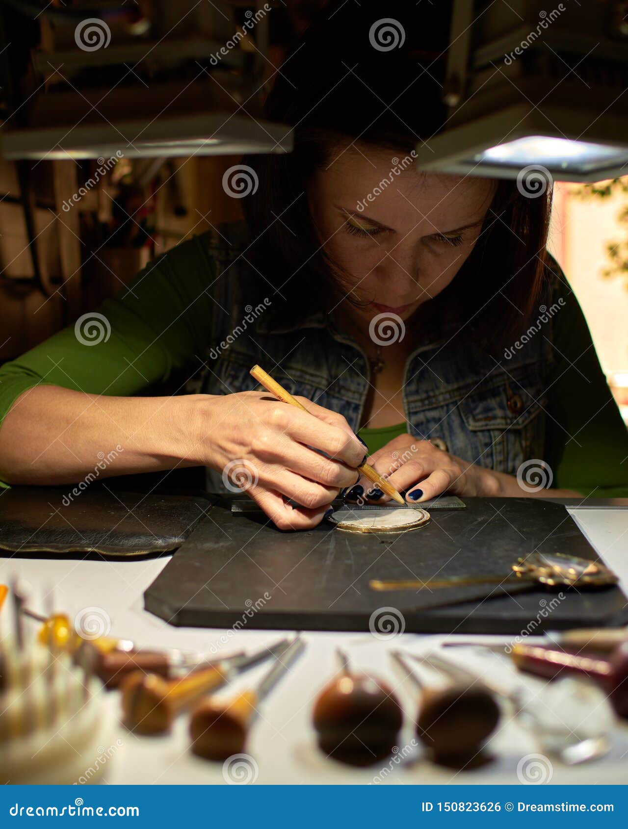 Woman engraver at work. stock photo. Image of material - 150823626