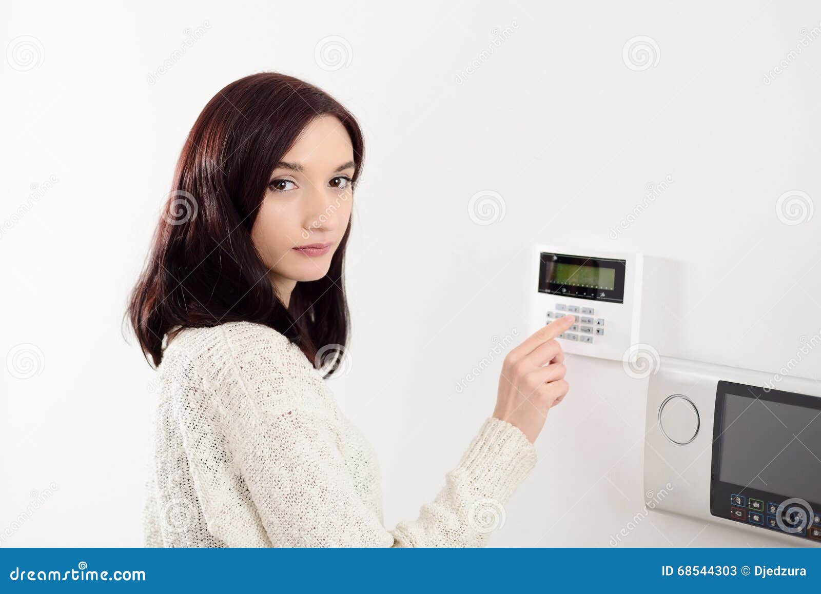 Woman Entering Code on Keypad of Home Security Alarm Stock Image ...