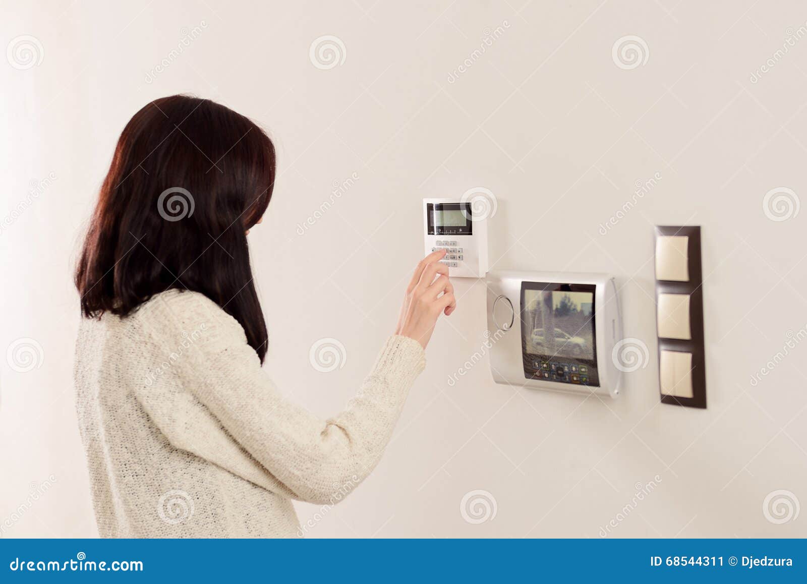 Woman Entering Code on Keypad of Home Security Alarm Stock Image ...