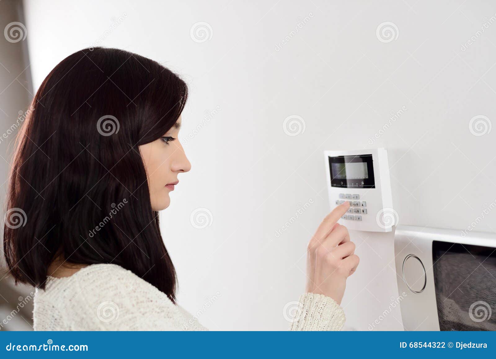 Woman Entering Code on Keypad of Home Security Alarm Stock Photo ...