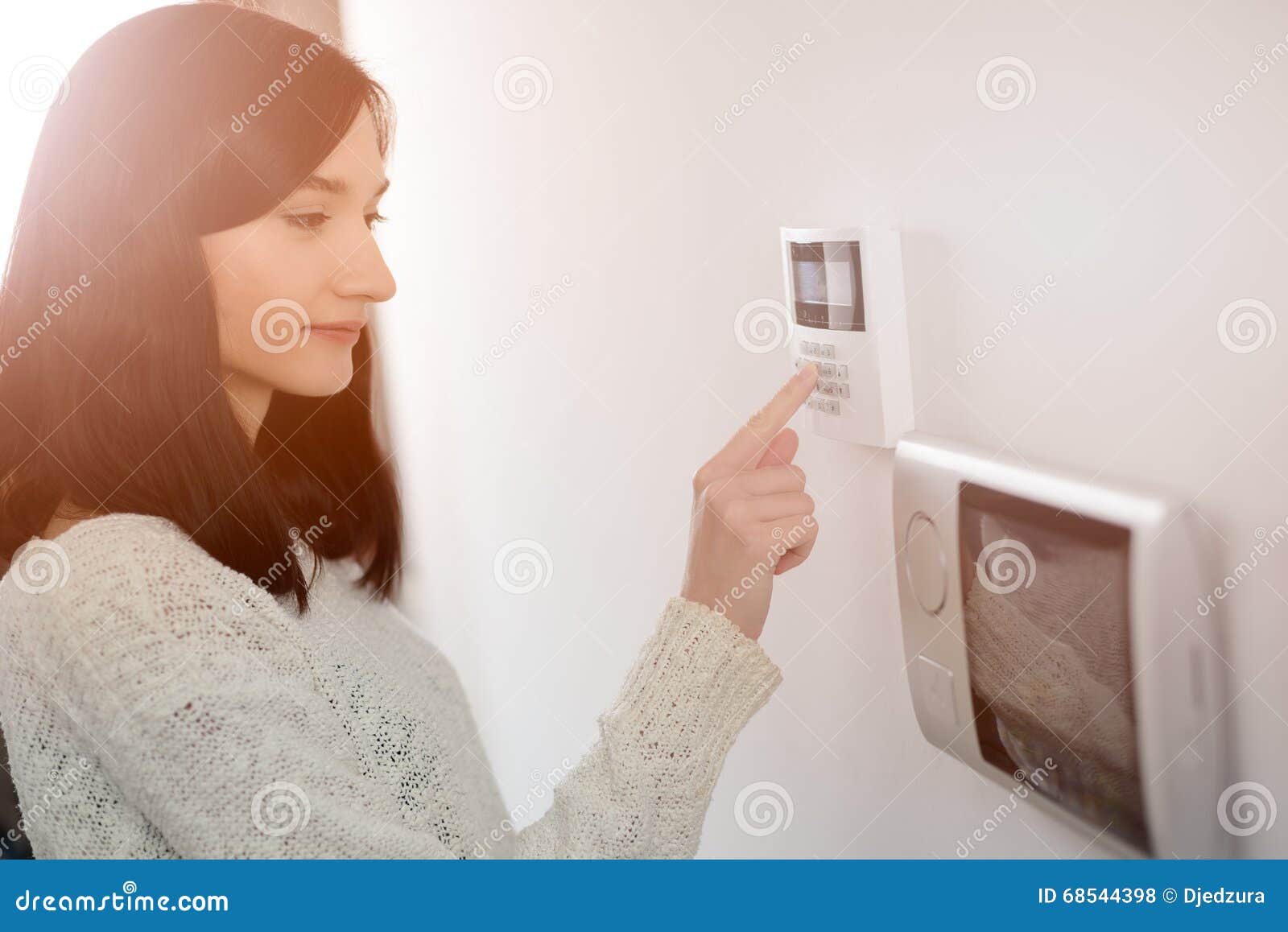 Woman Entering Code on Keypad of Home Security Alarm Stock Photo ...